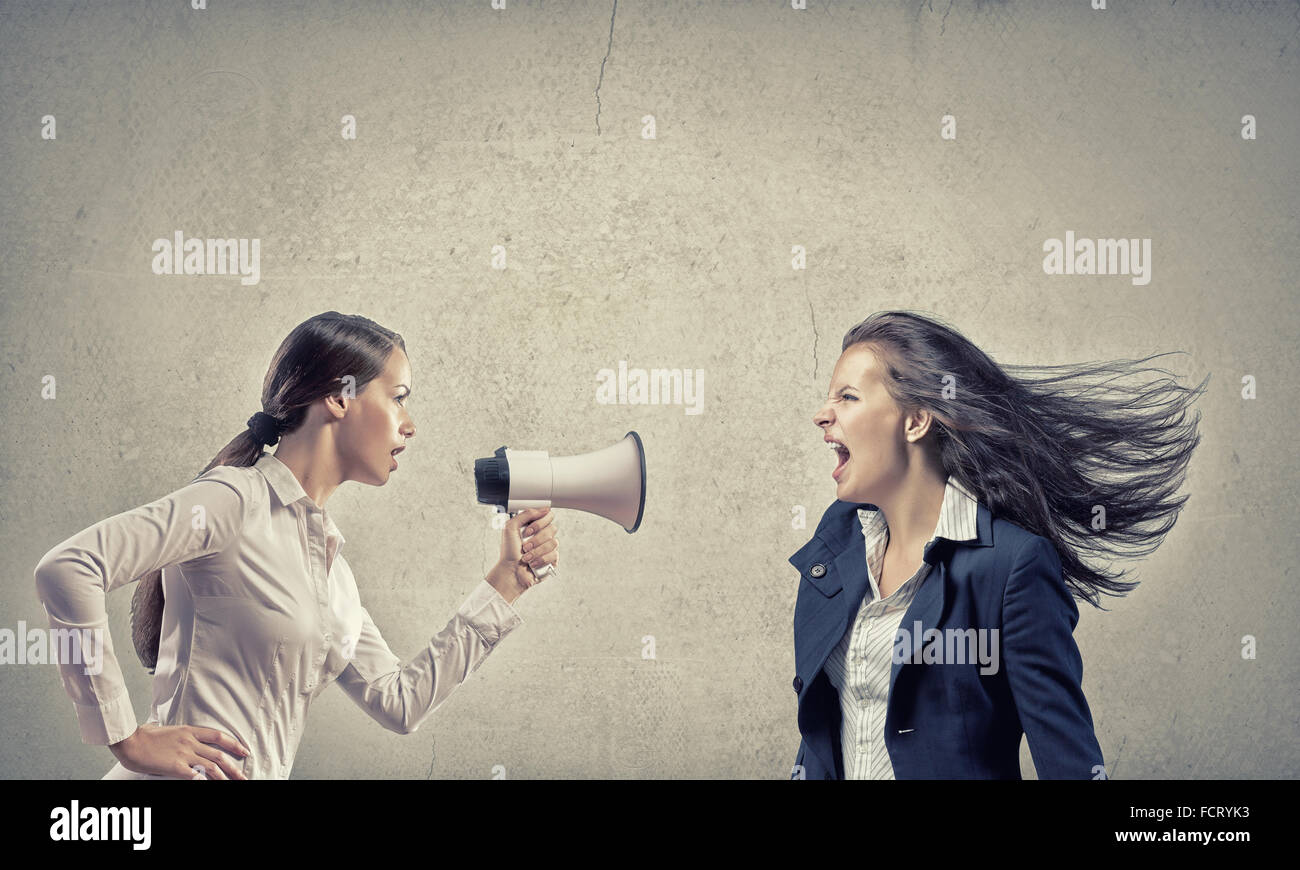 Young furious woman screaming agressively in megaphone Stock Photo - Alamy