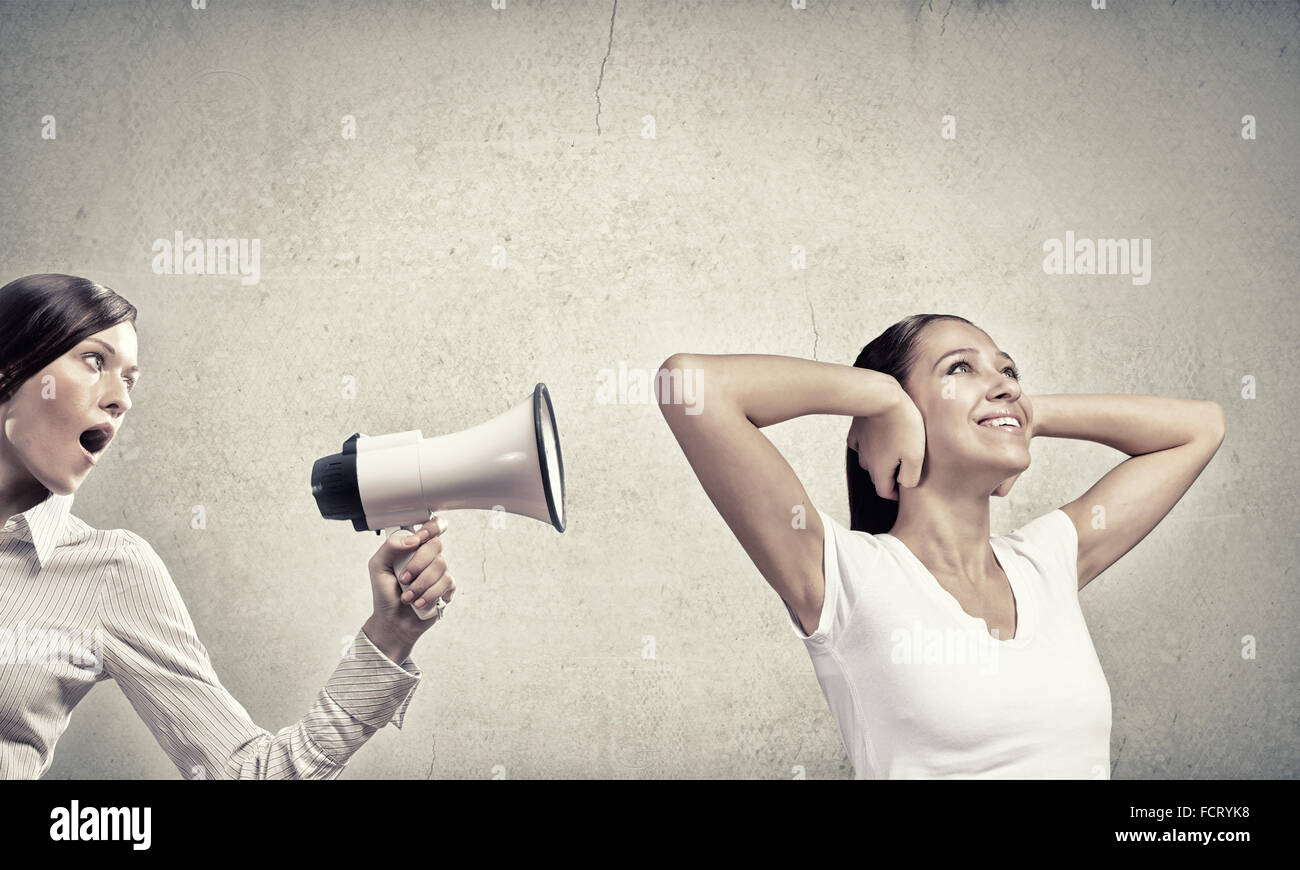 Young furious woman screaming agressively in megaphone Stock Photo - Alamy