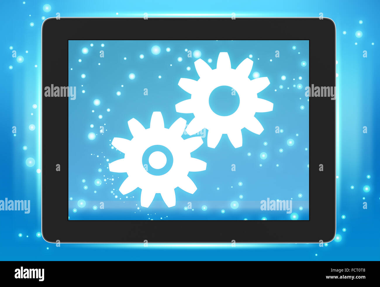 Screen tablet with icon gear wheels on screen Stock Photo - Alamy
