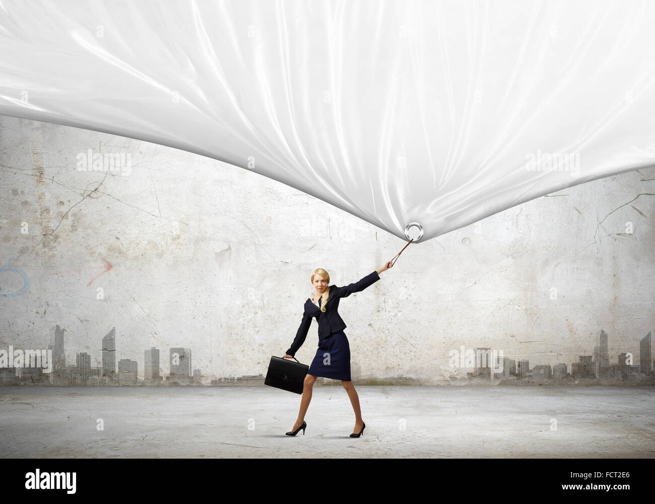 Young businesswoman with suitcase pulling white blank banner Stock ...