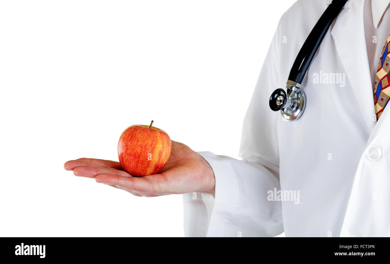 Partial side view of doctor holding apple in hand while wearing jacket ...