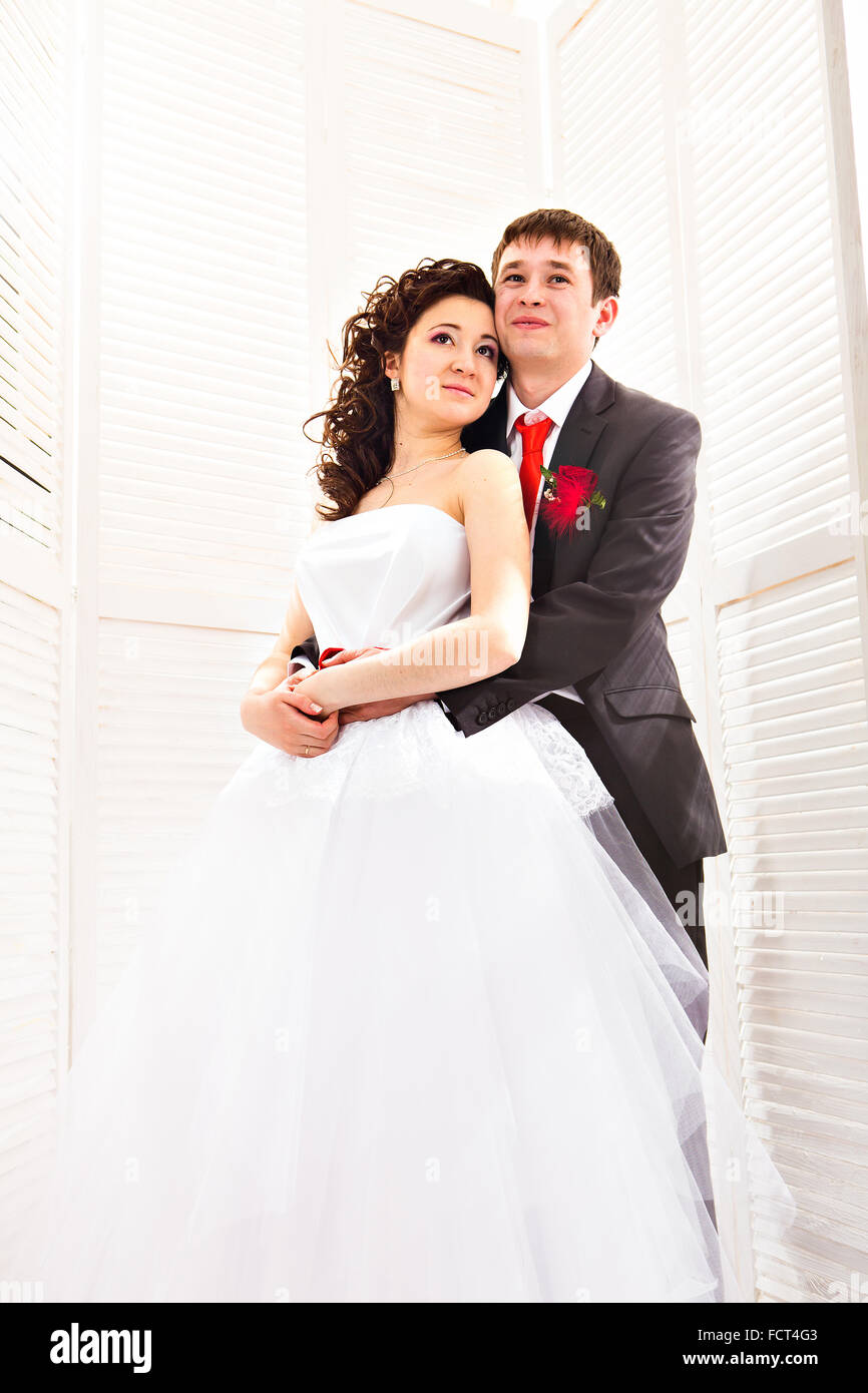 Wedding couple holding hands and hugging Stock Photo - Alamy
