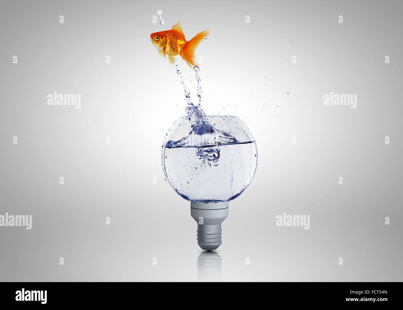 Goldfish jumping of light bulb filled with water Stock Photo - Alamy
