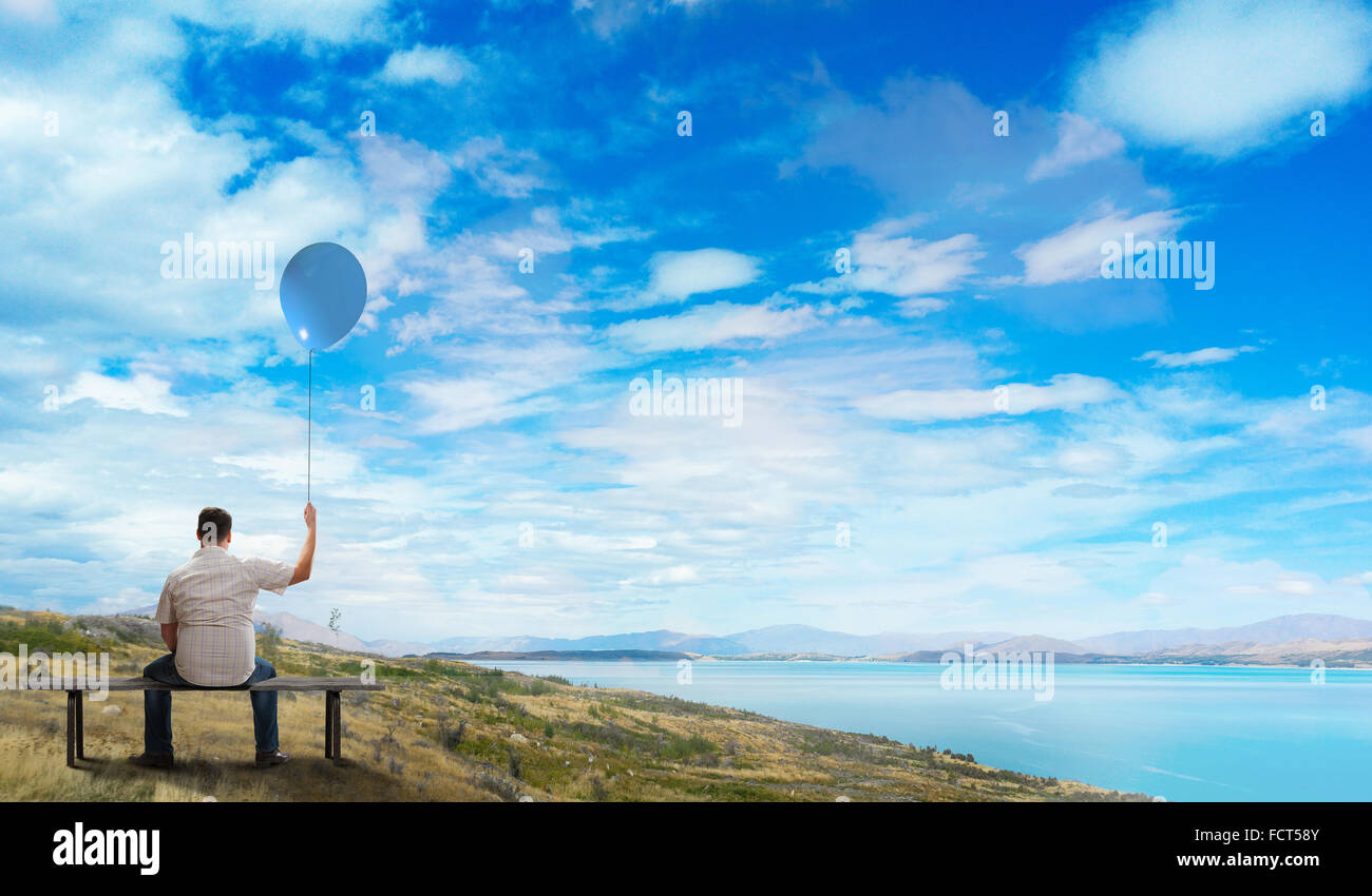 Fat man sitting on bench with his back with balloon in hand Stock Photo ...