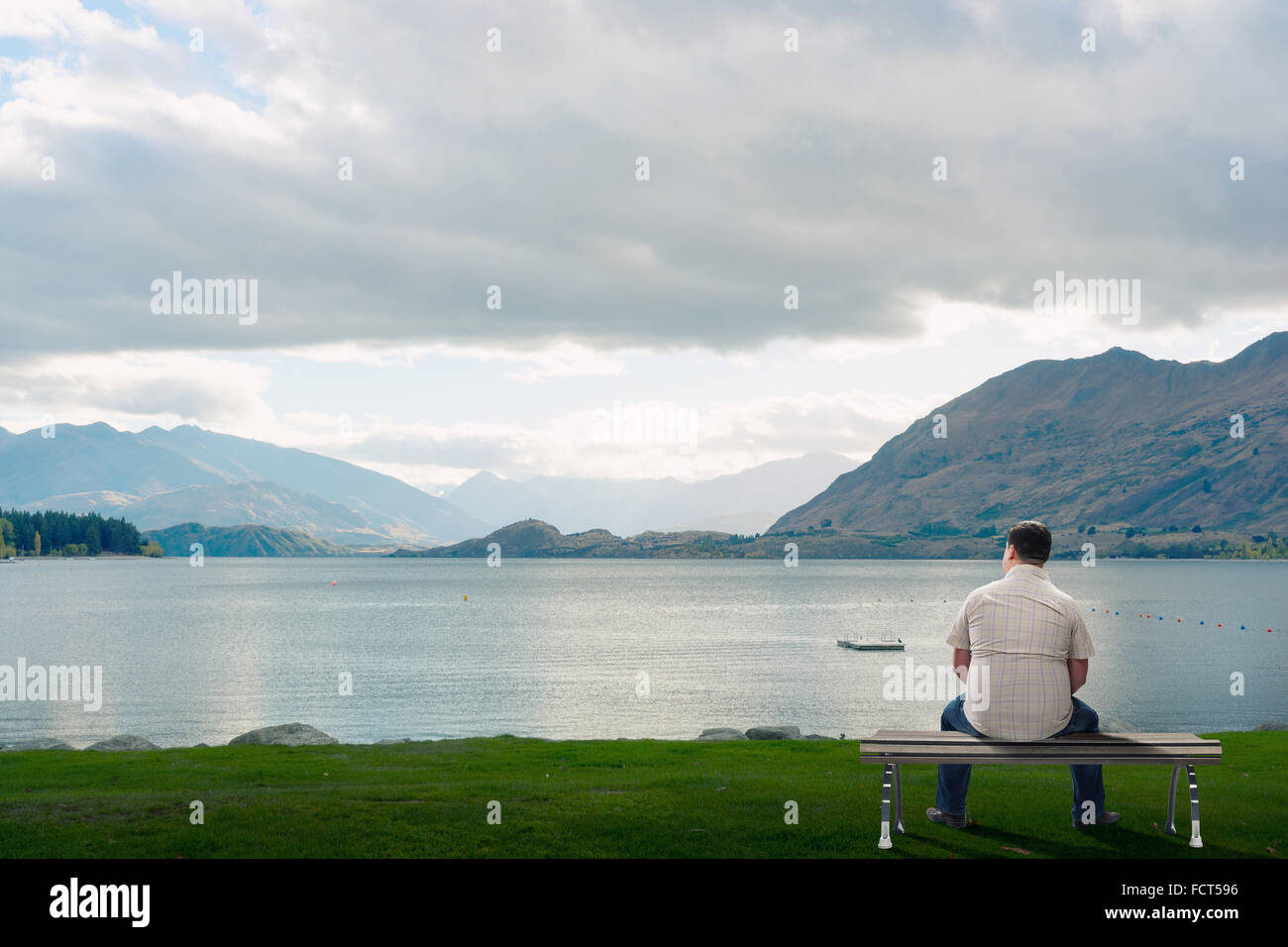 Fat man sitting on bench with his back and looking away Stock Photo - Alamy