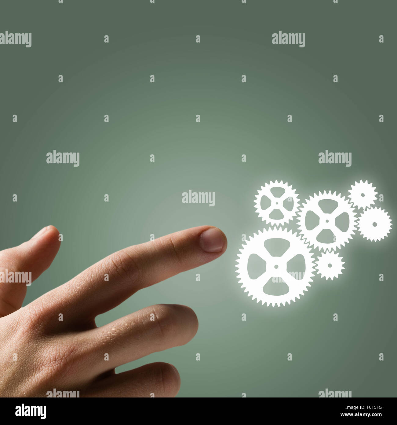 Close up of hand and gears mechanism on gray background Stock Photo - Alamy