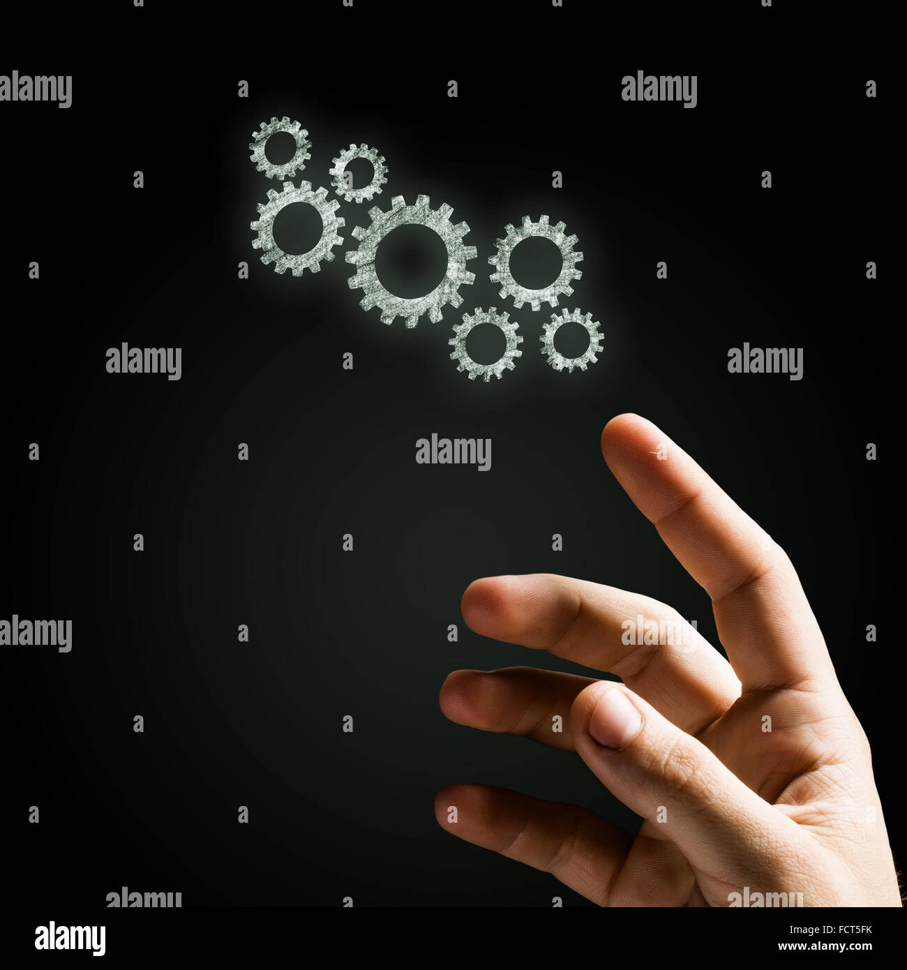 Close up of hand and gears mechanism on black background Stock Photo ...