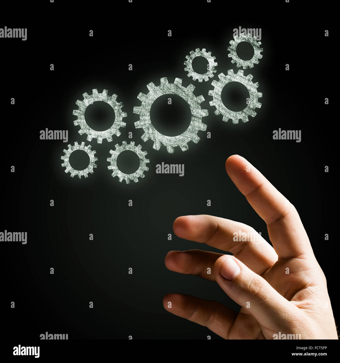 Close up of hand and gears mechanism on black background Stock Photo ...