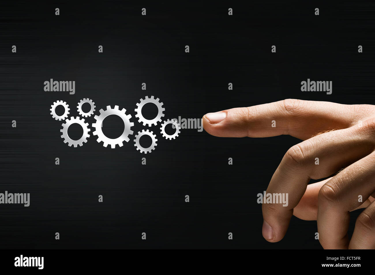 Close up of hand and gears mechanism on black background Stock Photo ...