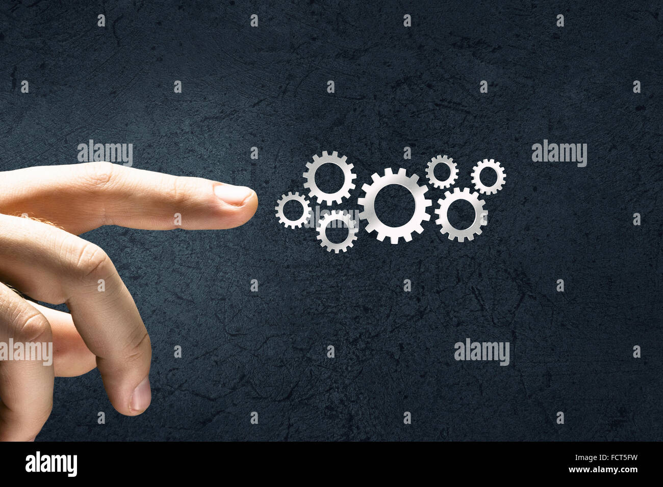 Close up of hand and gears mechanism on black background Stock Photo ...