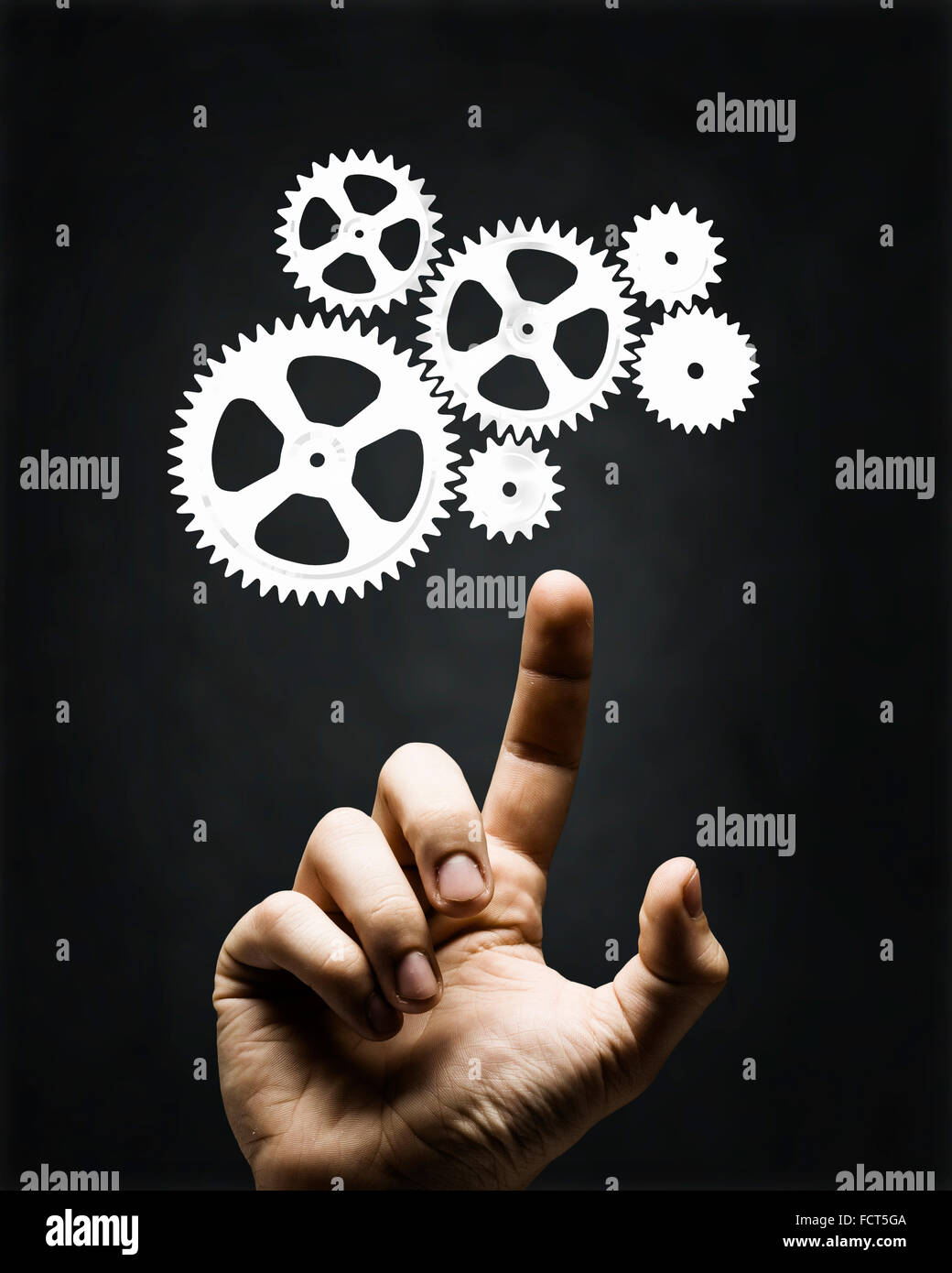 Close up of hand and gears mechanism on black background Stock Photo ...