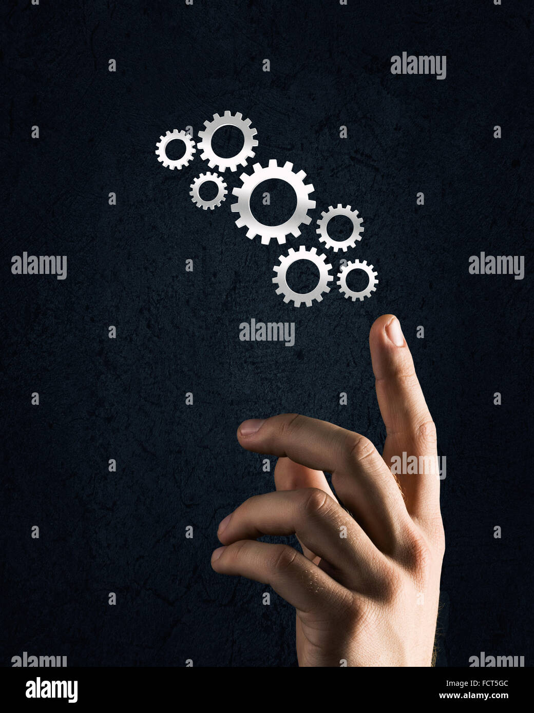 Close up of hand and gears mechanism on black background Stock Photo ...