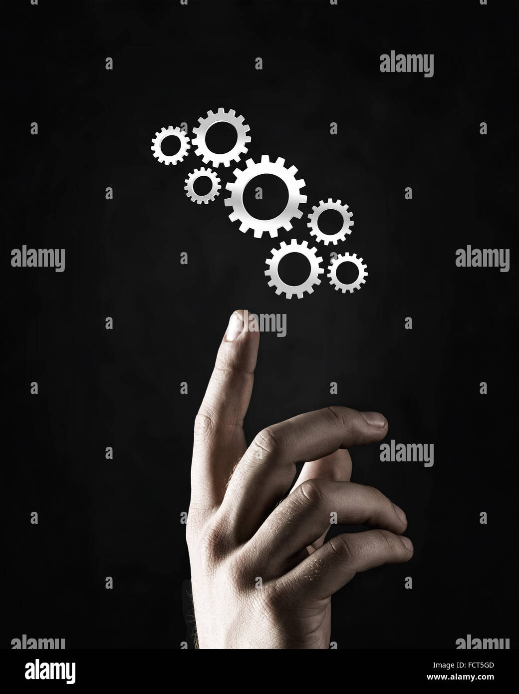 Close up of hand and gears mechanism on black background Stock Photo ...