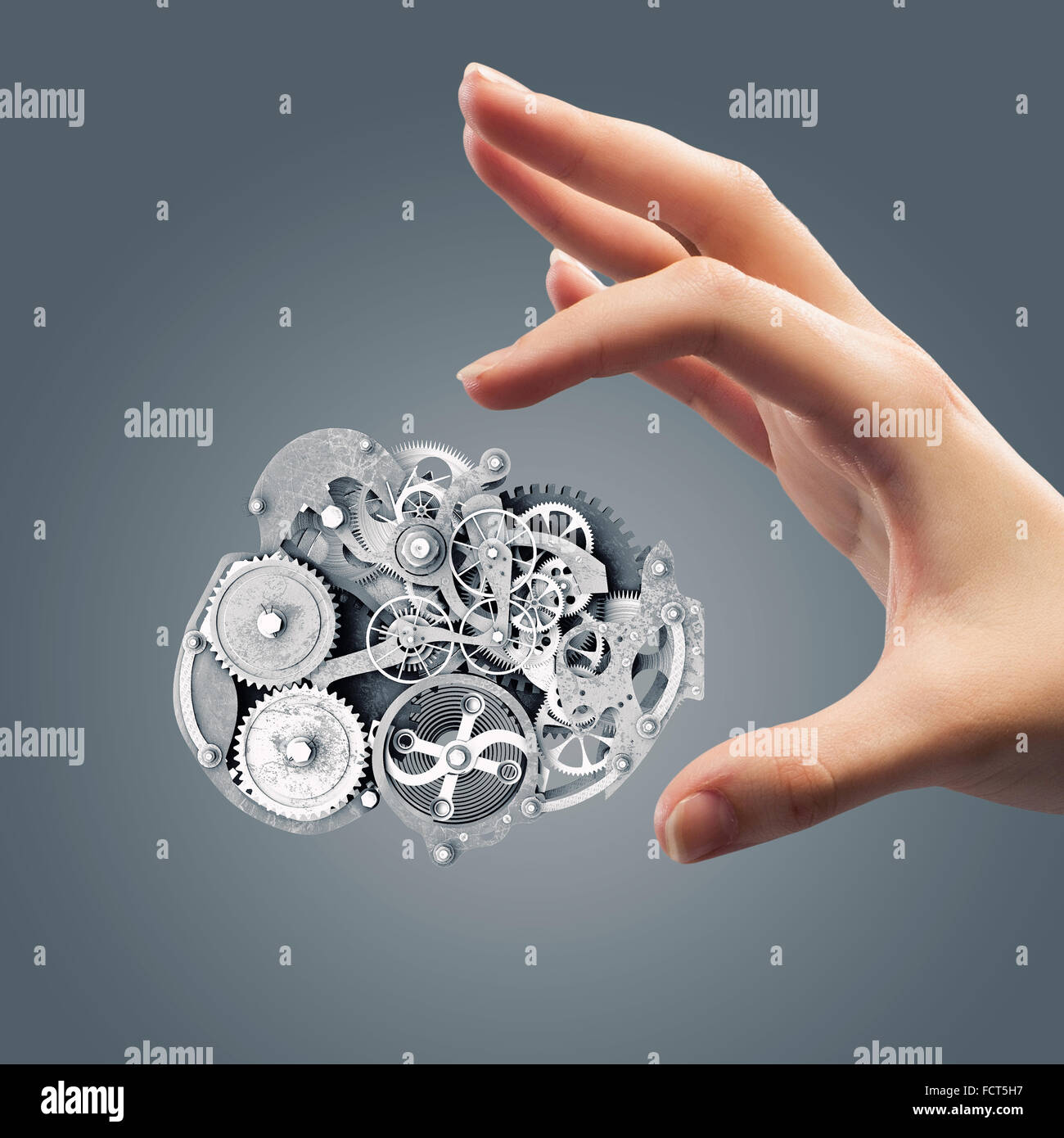 Close up of hand and gears mechanism on gray background Stock Photo - Alamy