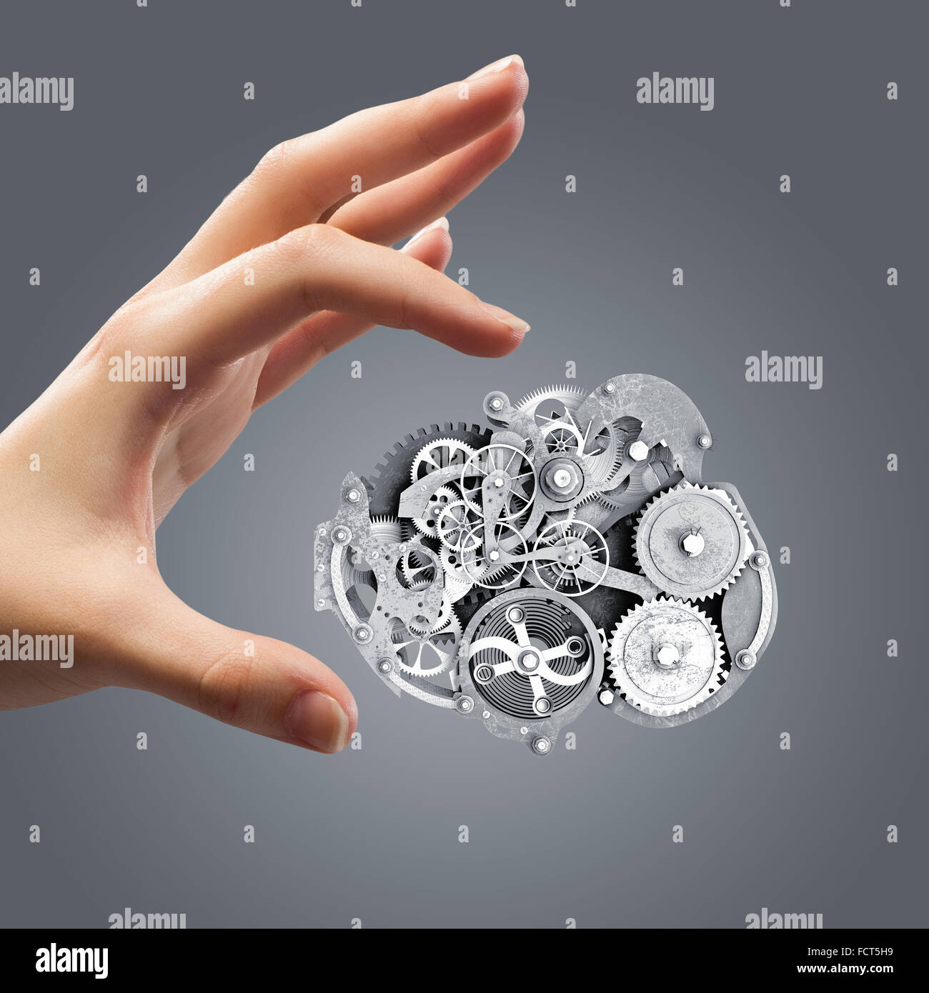 Close up of hand and gears mechanism on gray background Stock Photo - Alamy
