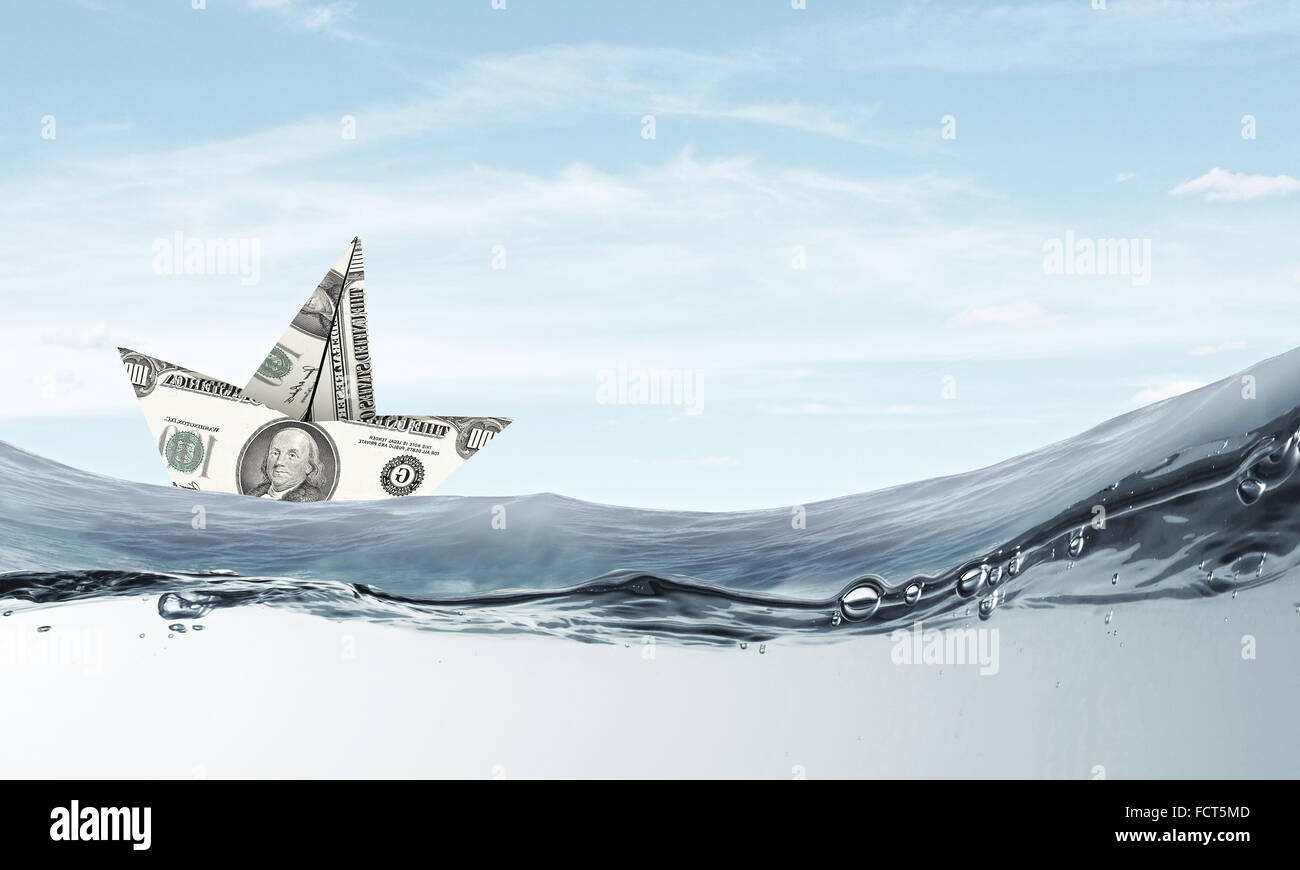 Ship made of dollar banknote floating in water Stock Photo - Alamy