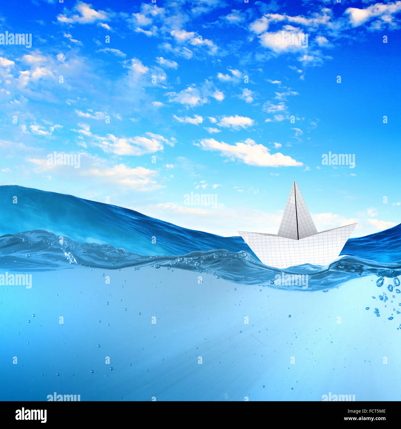 Boat made of paper sailing on blue water surface Stock Photo - Alamy