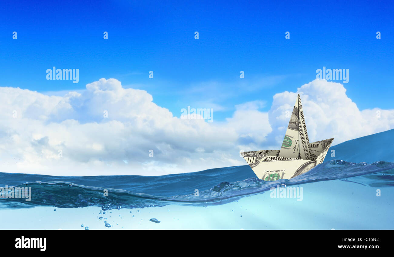 Ship made of dollar banknote floating in water Stock Photo - Alamy