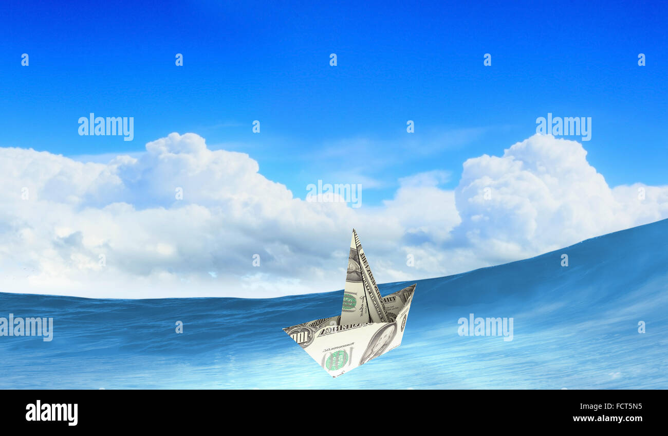 Ship made of dollar banknote floating in water Stock Photo - Alamy