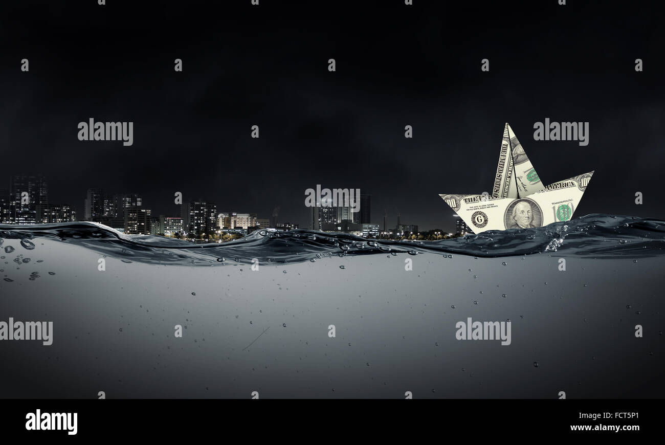 Ship made of dollar banknote floating in water Stock Photo - Alamy