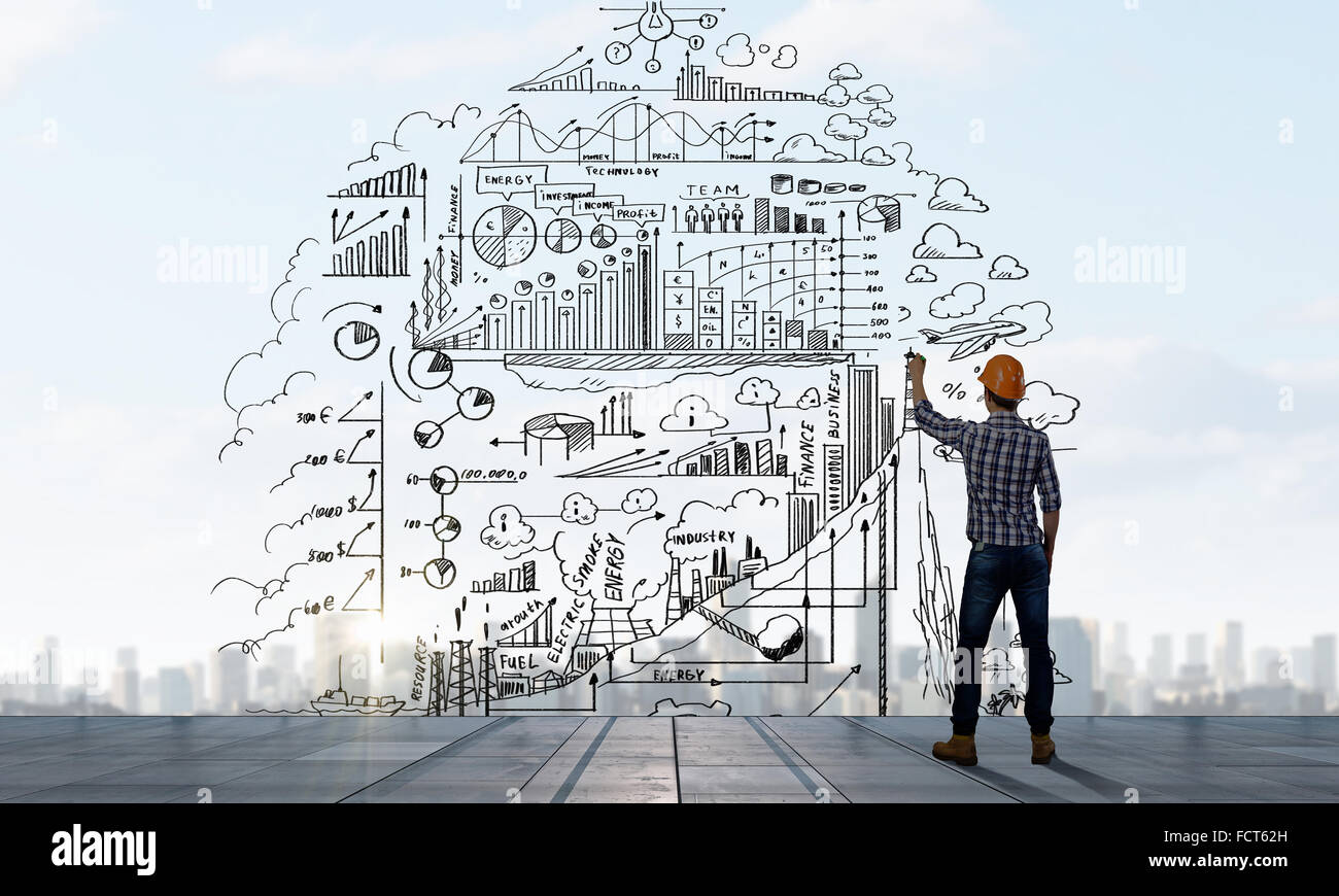 Back view of man engineer drawing plan sketches on wall Stock Photo - Alamy