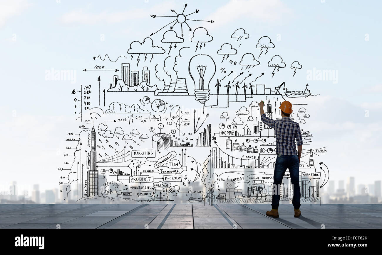 Back view of man engineer drawing plan sketches on wall Stock Photo - Alamy