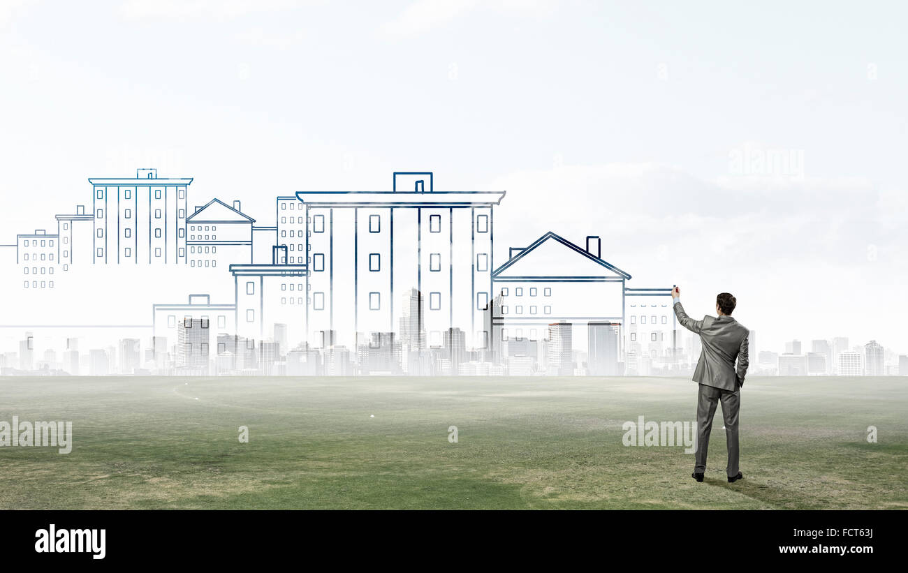 Back view of man engineer drawing plan sketches on wall Stock Photo - Alamy