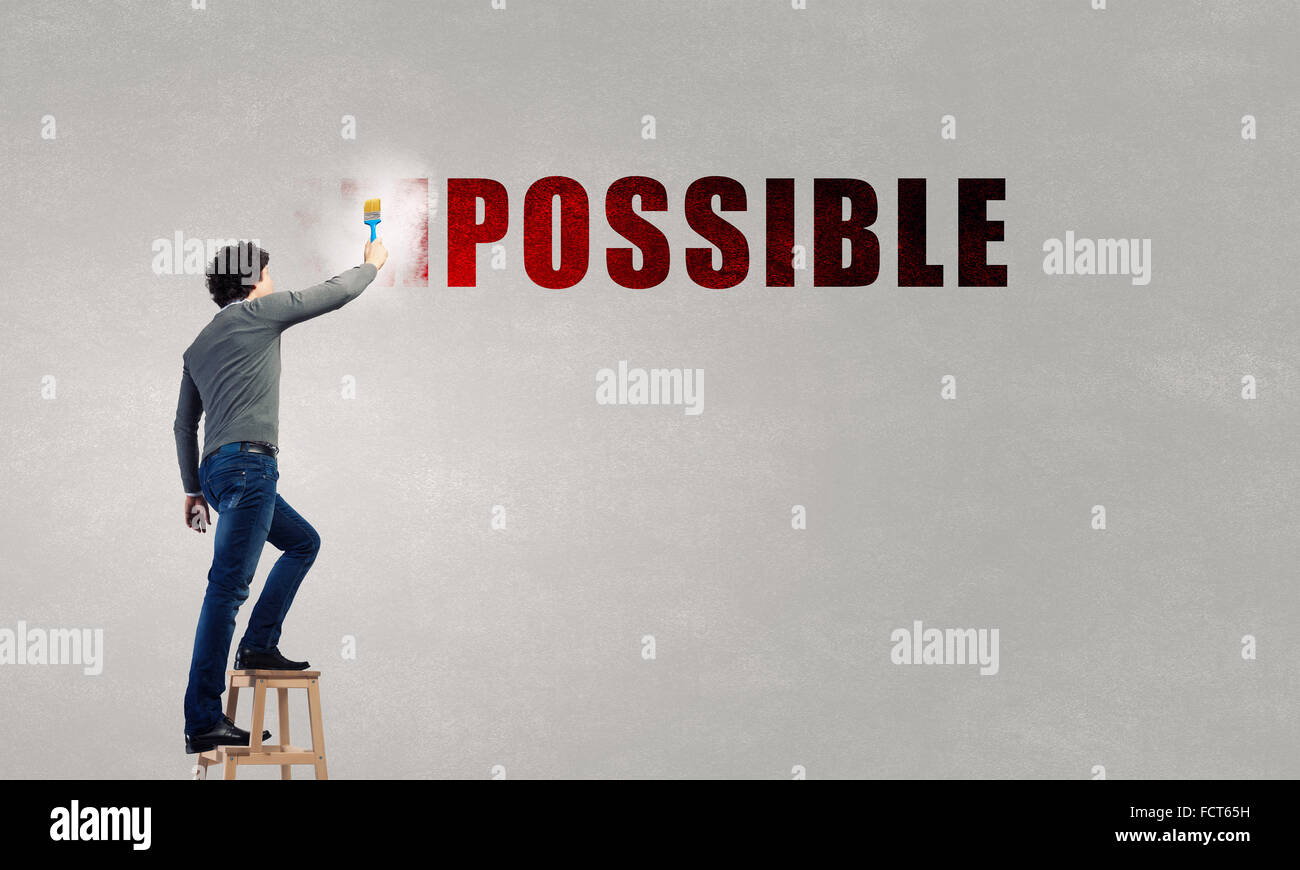 Man changing word impossible in to possible by erasing part of word ... Man changing word impossible in to possible by erasing part of word ...