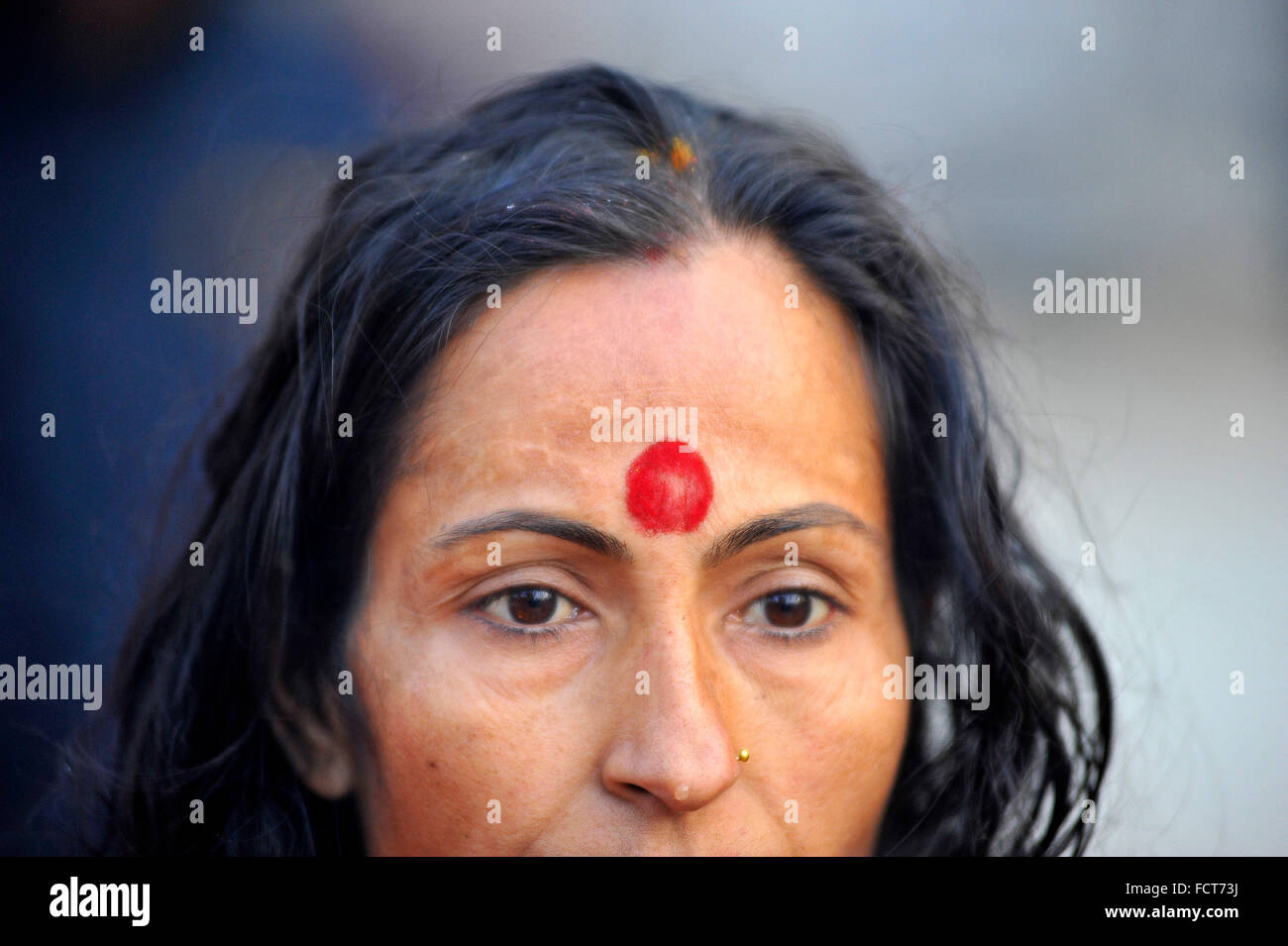 Kathmandu, Nepal. 24th Jan, 2016. Nepalese devotee puts RED CIRCLE tika ...
