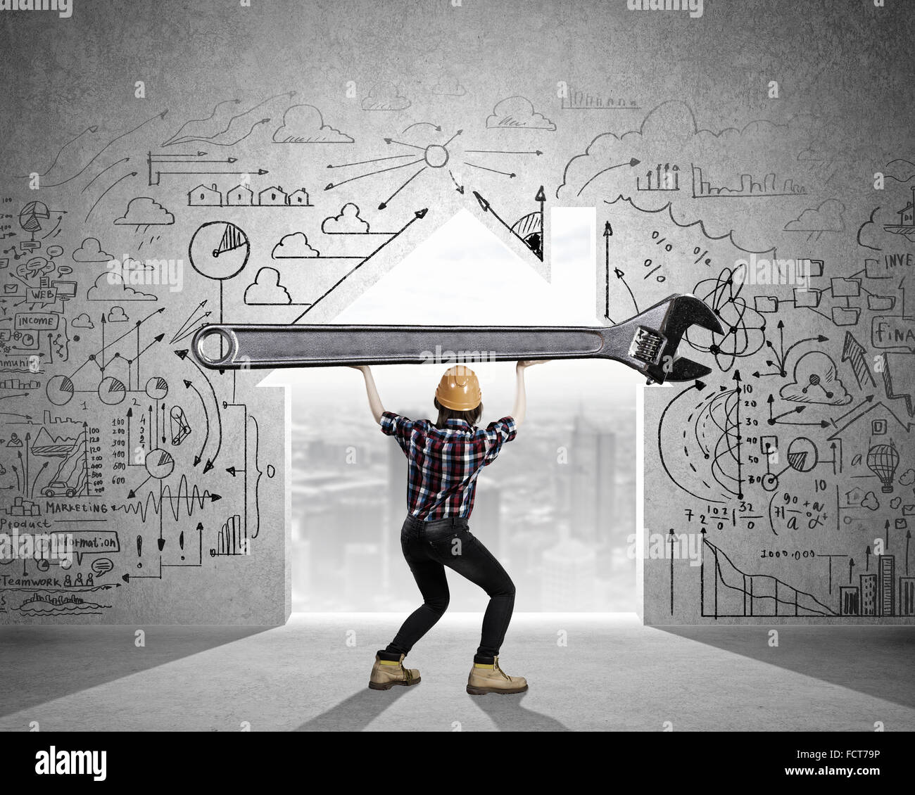 Young engineer woman lifting big wrench key above head Stock Photo - Alamy