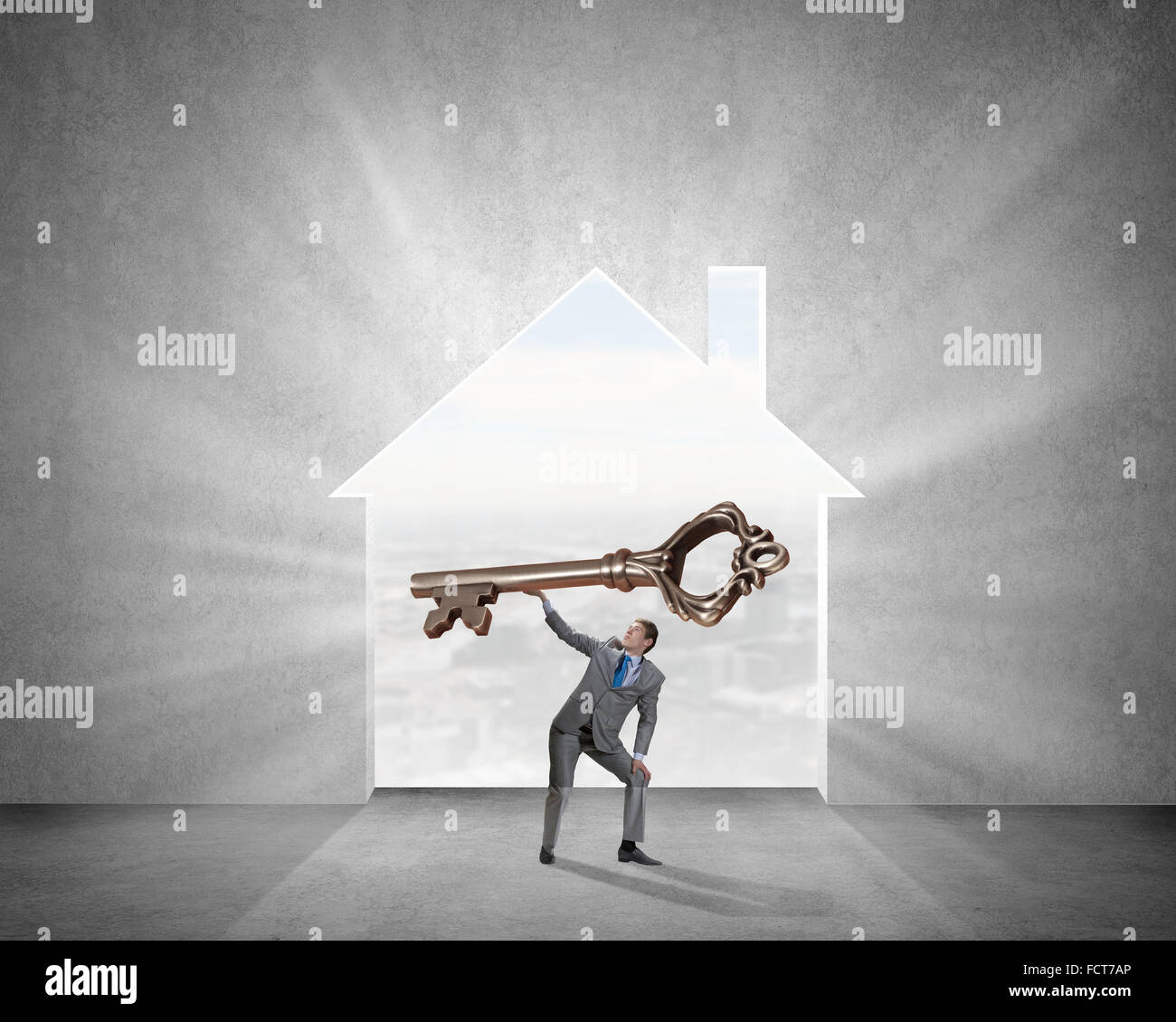 Young businessman and lifting big key above head Stock Photo - Alamy