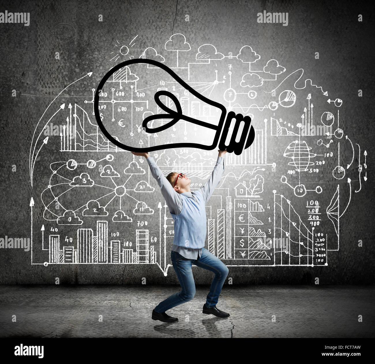 Young man lifting light bulb above head Stock Photo - Alamy