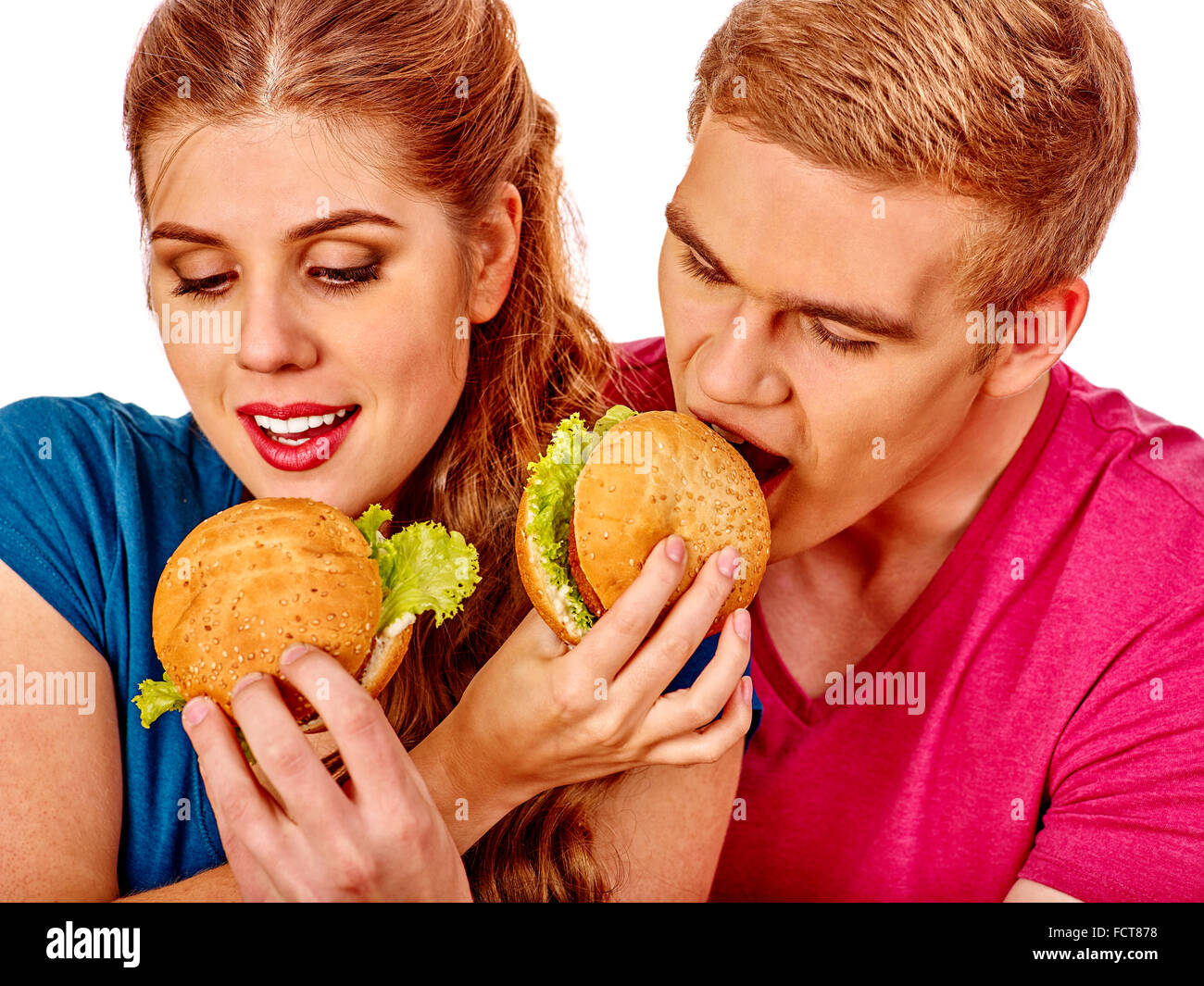 Man and woman eating big sandwich with cola. Isolated Stock Photo - Alamy