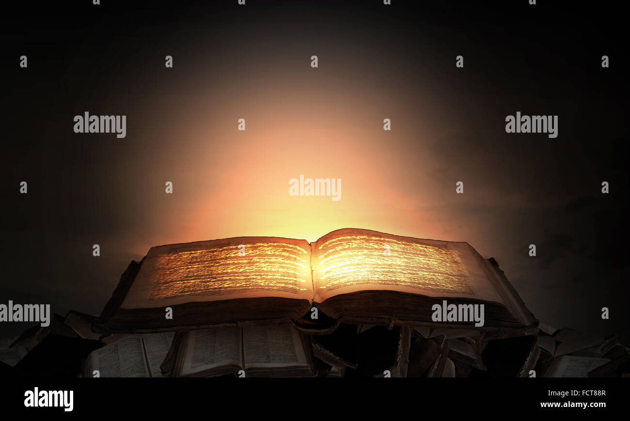 Old black magic book with lights on pages Stock Photo - Alamy
