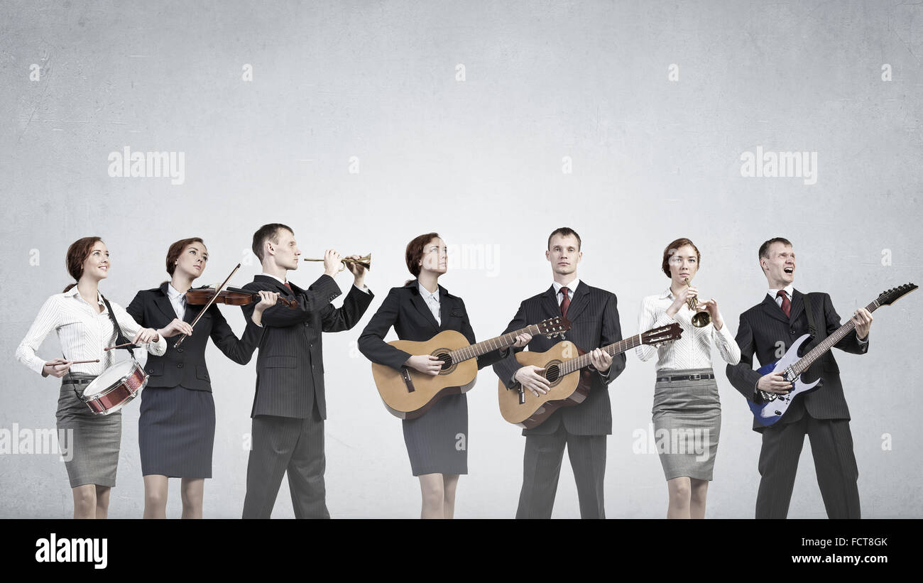 Young woman in suit playing different music instruments Stock Photo - Alamy