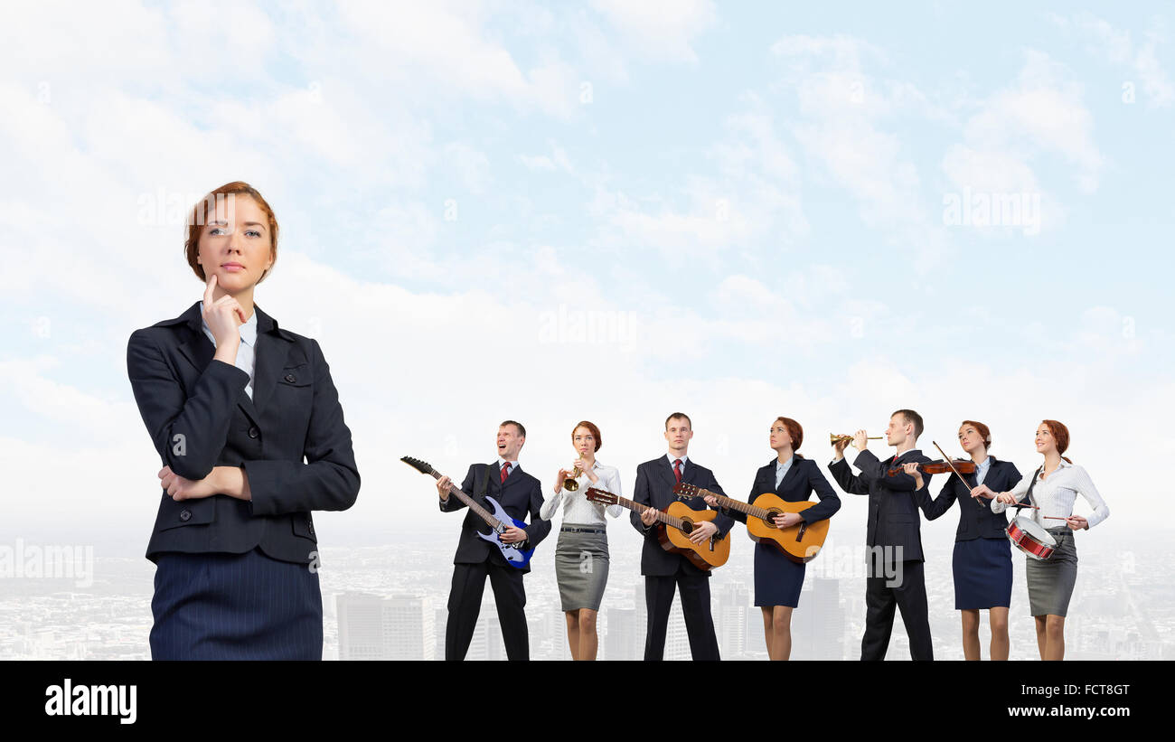 Young woman in suit playing different music instruments Stock Photo - Alamy