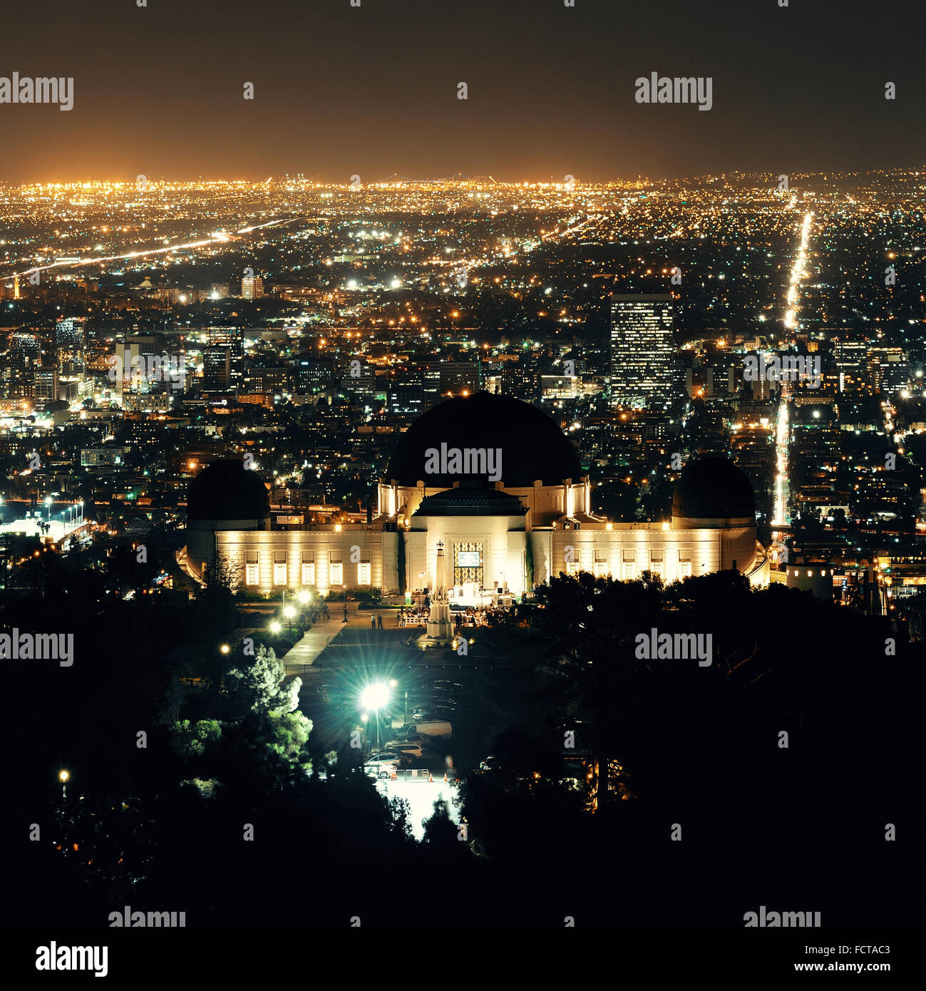 Los Angeles at night with urban buildings and Griffith Observatory ...