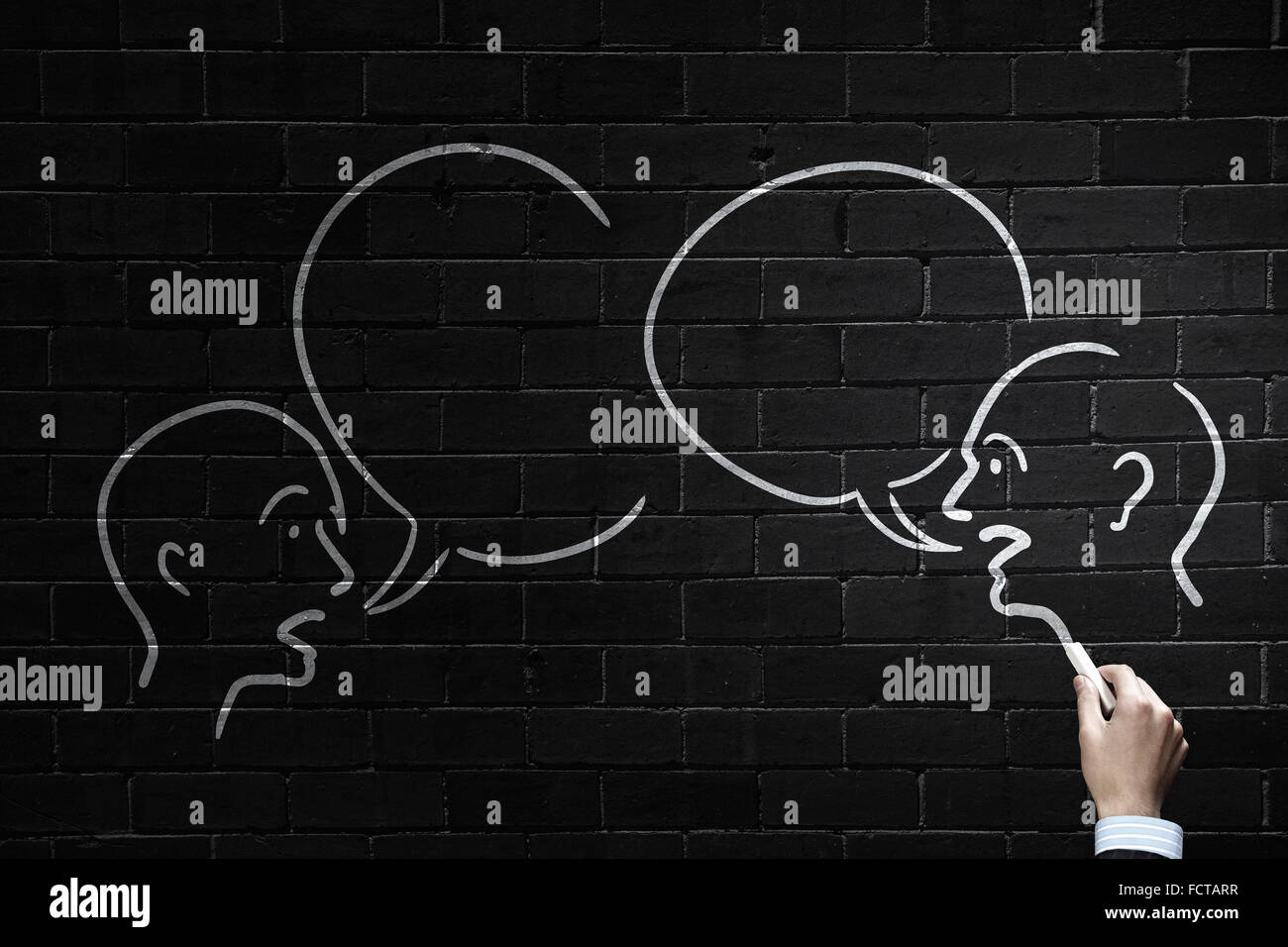 Close up of hand drawing dialogue between two on black wall Stock Photo ...