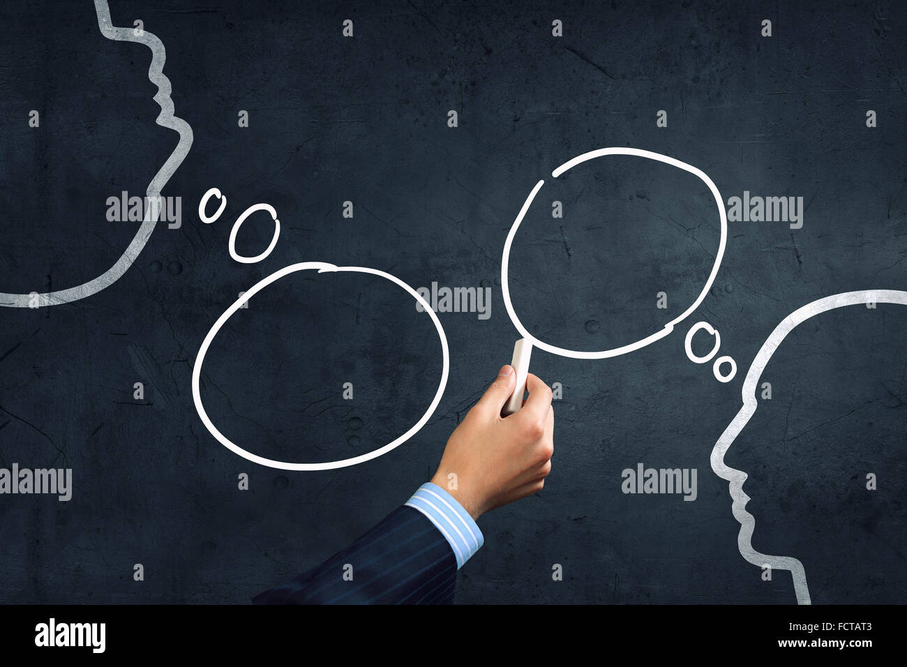 Close up of hand drawing dialogue between two on black wall Stock Photo ...