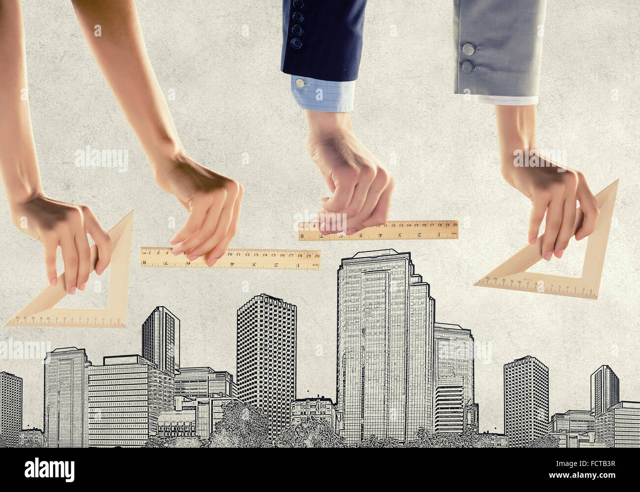 Close up of male hand measuring with ruler model of city Stock Photo ...