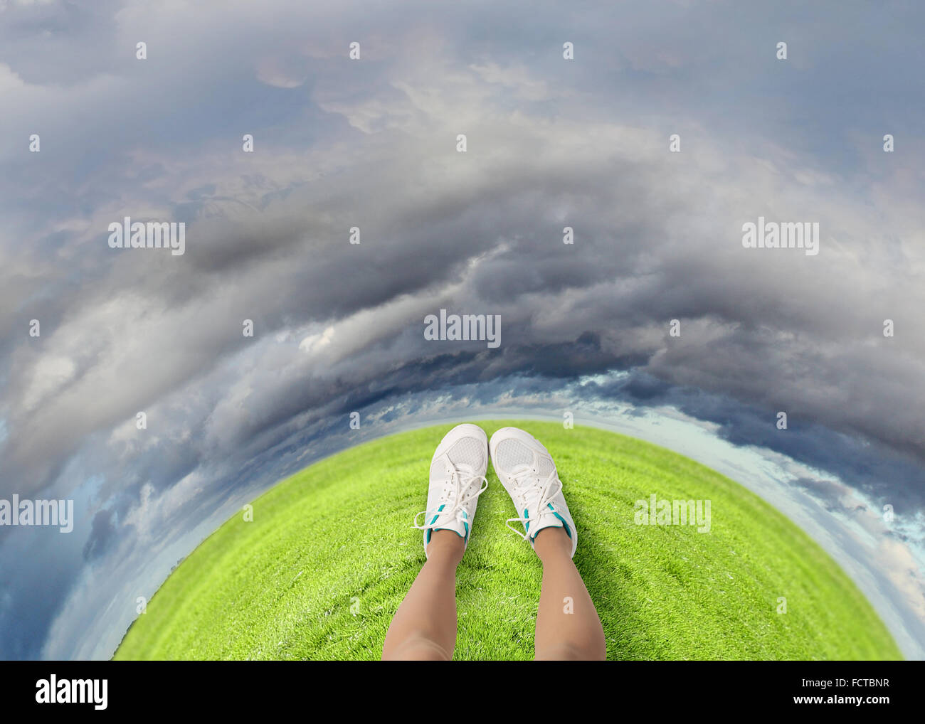 Top view of female feet in white sneakers standing on grass Stock Photo ...
