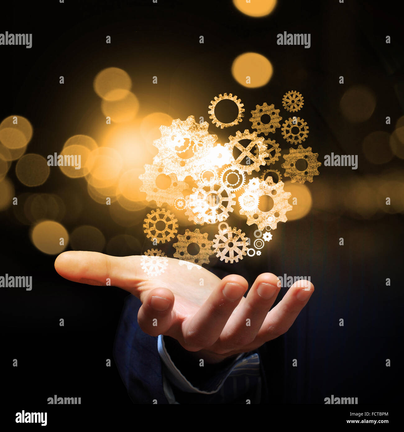Close up of human hand holding gear icons Stock Photo - Alamy