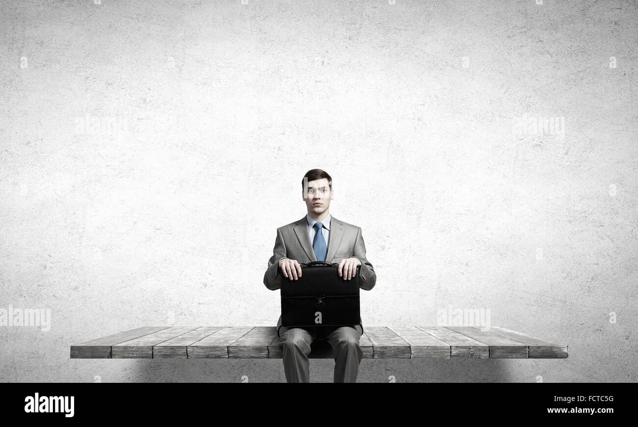 Young handsome businessman with briefcase in hands Stock Photo - Alamy