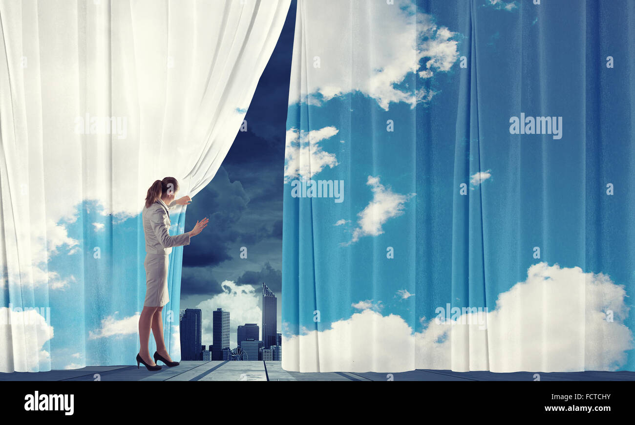Businesswoman pulling curtain and cityscape behind it Stock Photo - Alamy