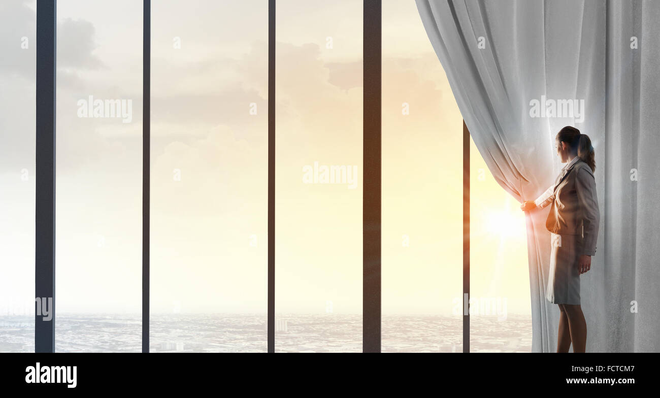 Businesswoman pulling curtain and cityscape behind it Stock Photo - Alamy