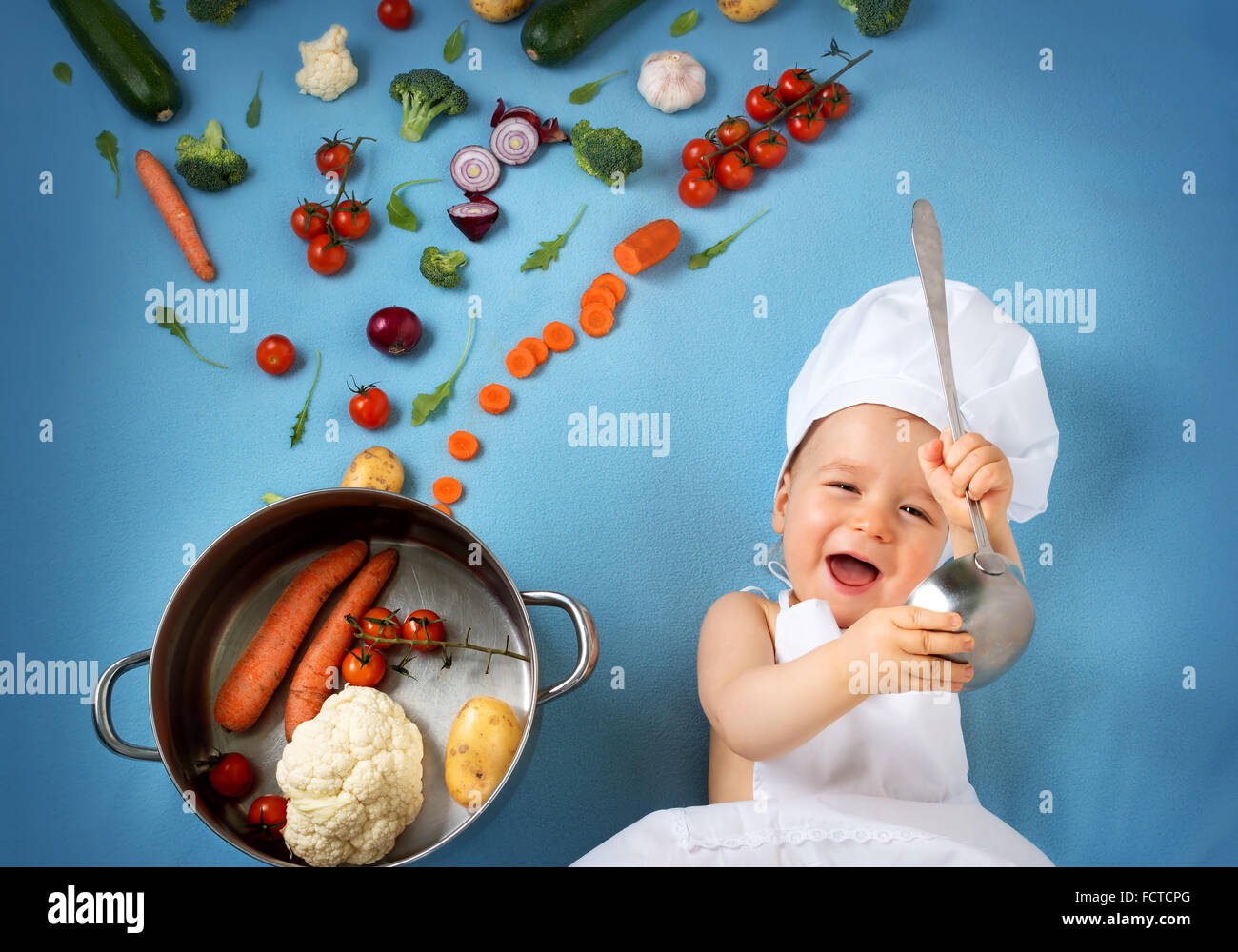 Baby boy in chef hat with cooking pan and vegetables Stock Photo - Alamy