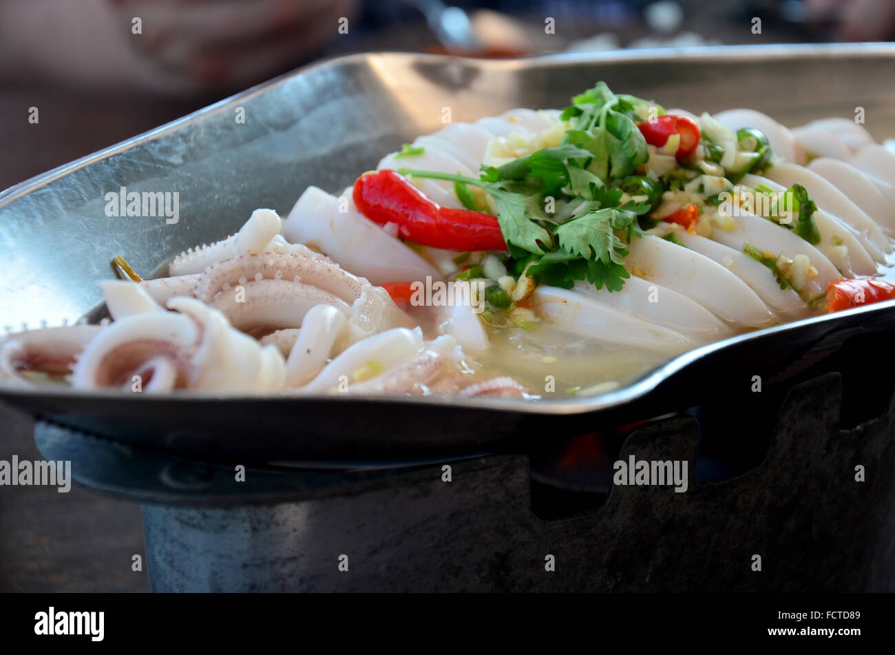 Steamed squid with spicy chilli and lemon sauce at restaurant in ...