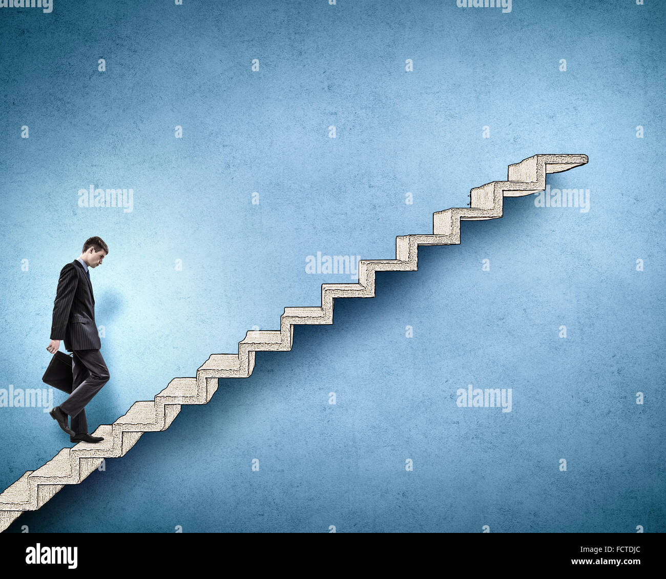 Young tired businessman walking up on staircase representing success ...