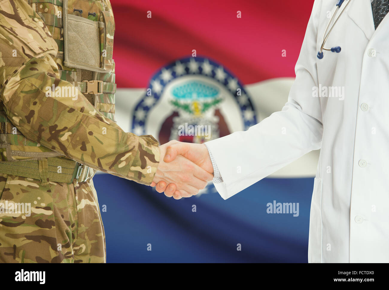 Soldier in uniform and doctor shaking hands with US states flags on ...
