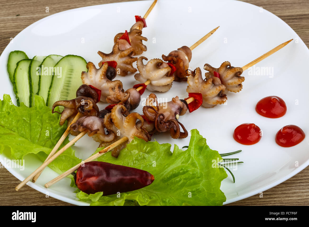 Barbecue baby octopus with bell pepper and spices Stock Photo - Alamy
